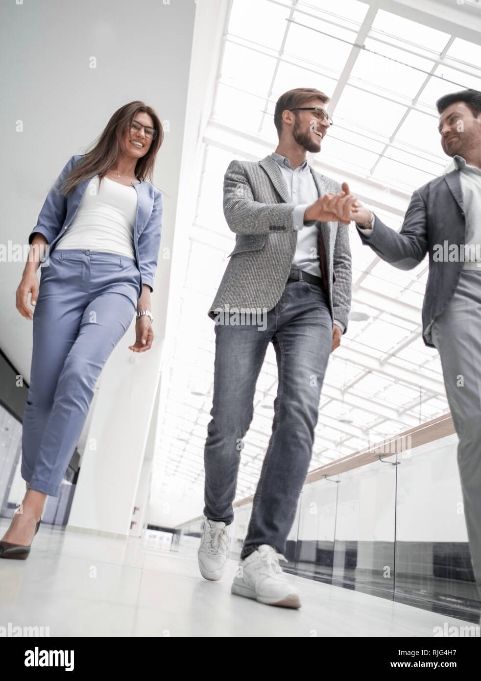 employees greet each other in the office building Stock Photo - Alamy