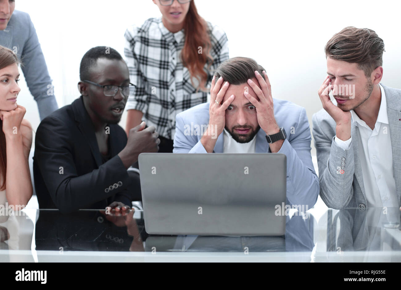 group of people looking at laptop Stock Photo - Alamy