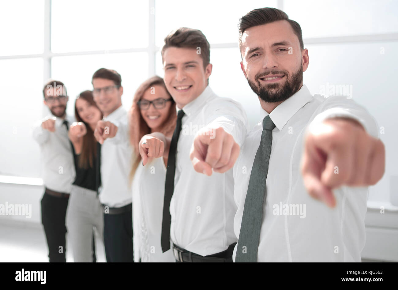 business team standing in new office and pointing forward Stock Photo ...