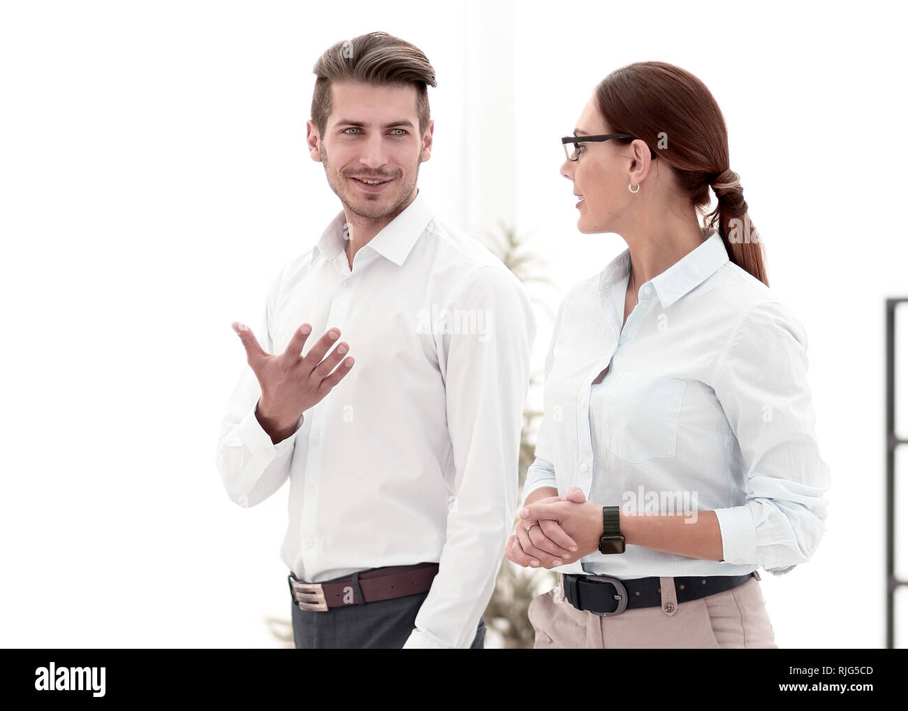 Manager and the employee are on the office corridor Stock Photo - Alamy
