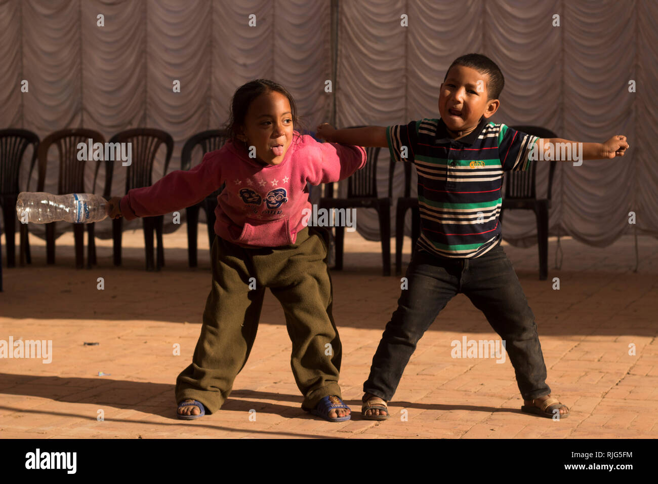 Two kids playing in the light Stock Photo - Alamy