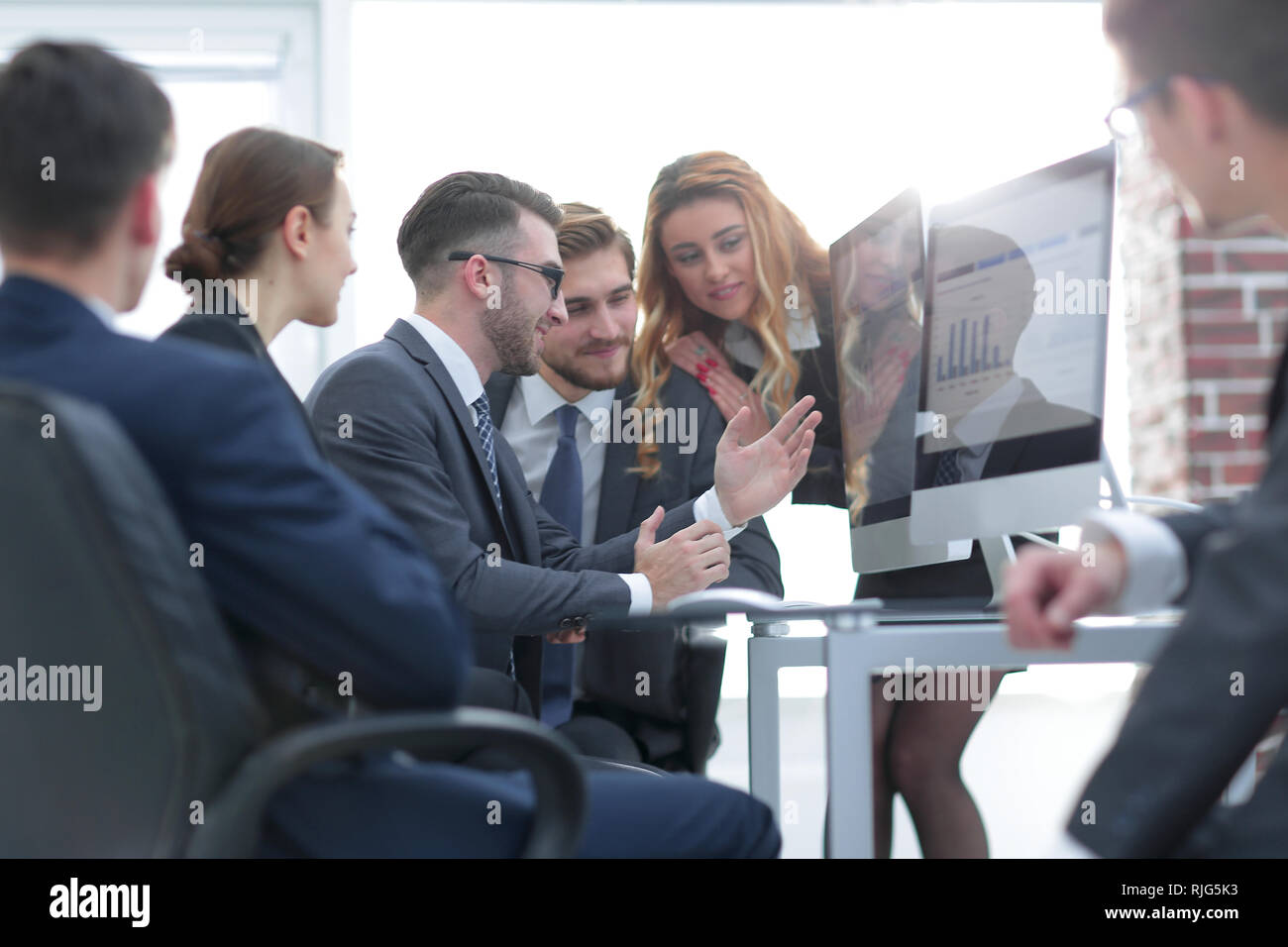 employees discussing financial charts Stock Photo - Alamy