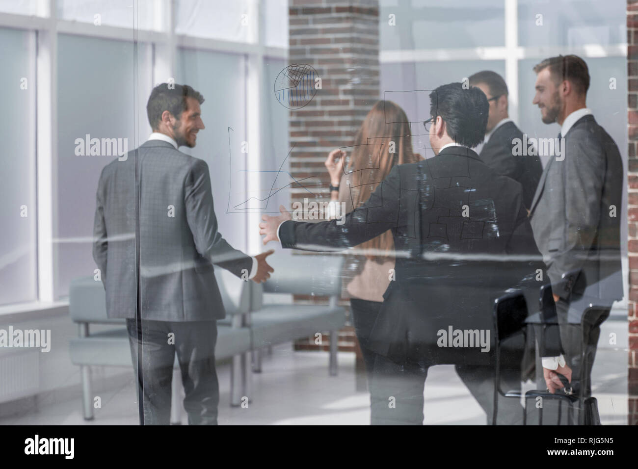 Business people from the back - looking at something Stock Photo - Alamy