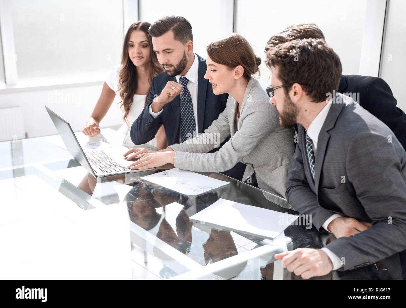 business team sitting at the Desk in the meeting room Stock Photo - Alamy