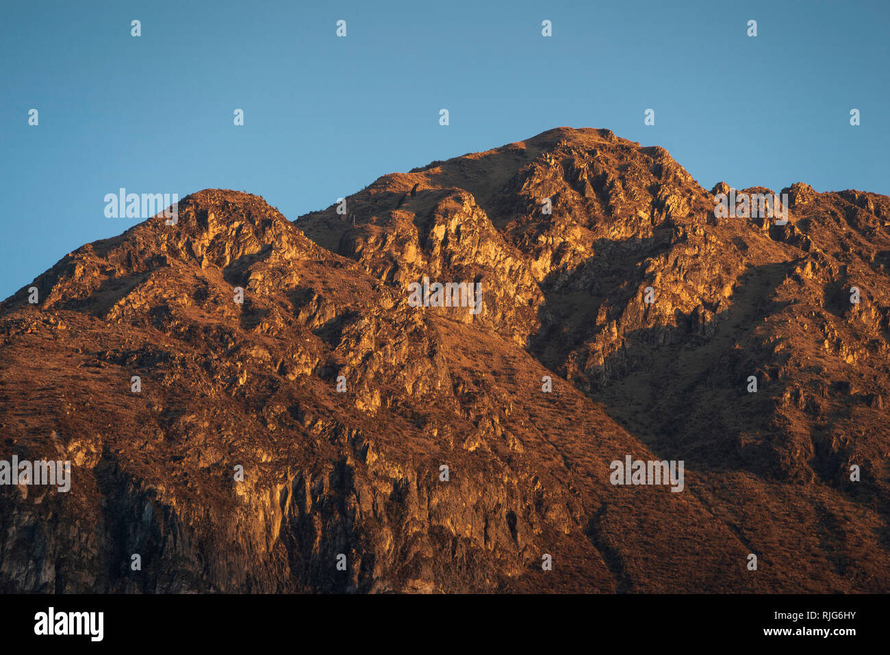 sunset landscape of severe mountain ridge and clear blue sky above ...