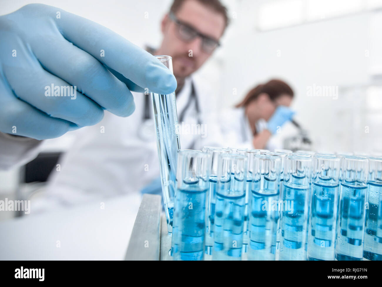 serious scientist working with liquids Stock Photo - Alamy
