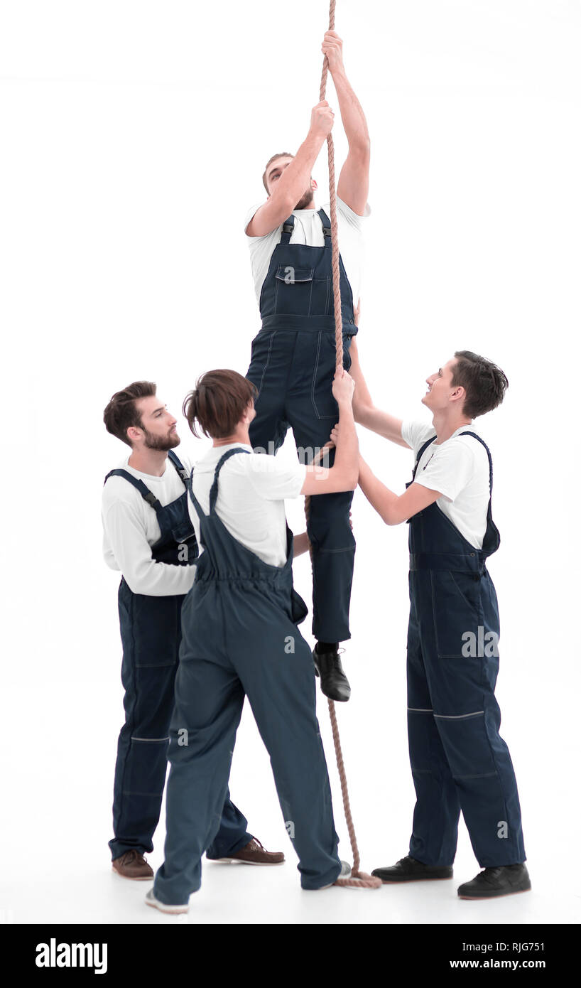 view from the top. team work in helping the leader to climb up Stock ...