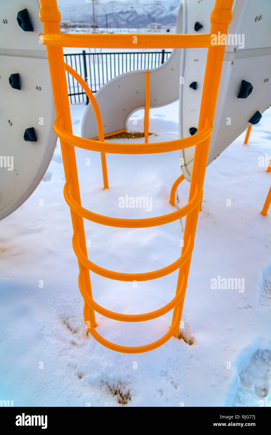 Ladder of playground climber against snowy ground Stock Photo - Alamy