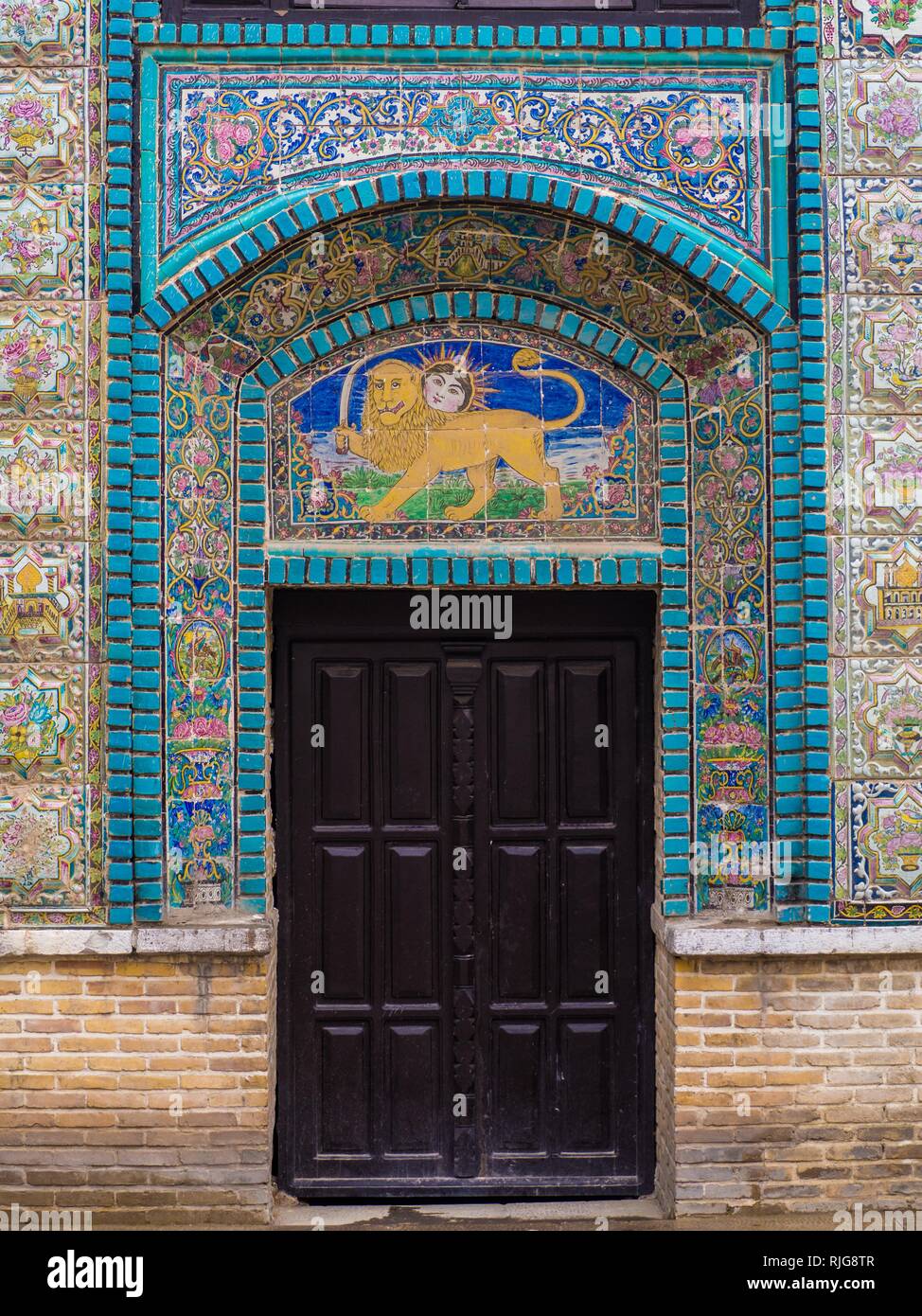 Tile picture over wooden door, Persian national symbol, sun over lion ...