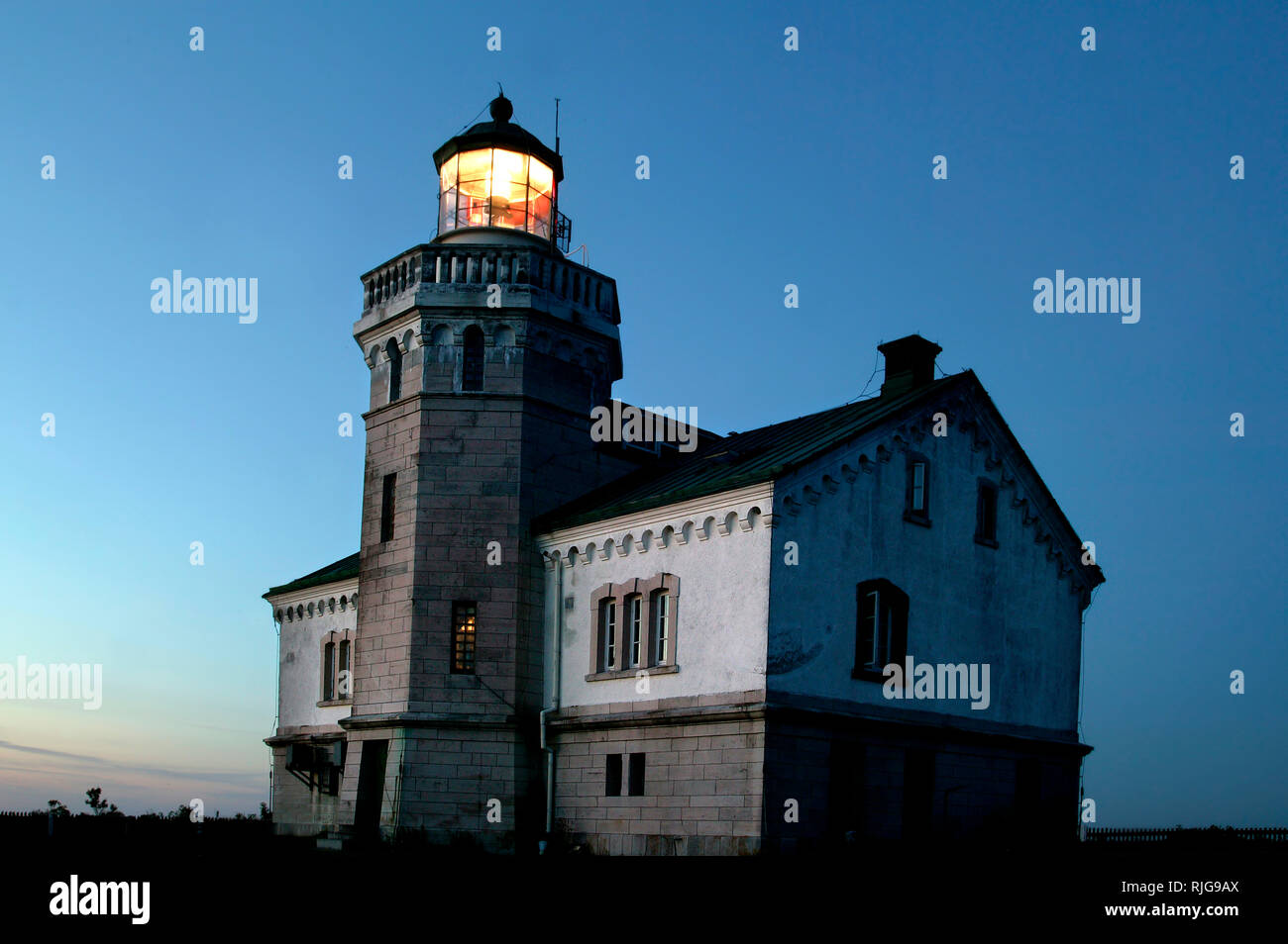 Lighthouse at dusk Stock Photo - Alamy