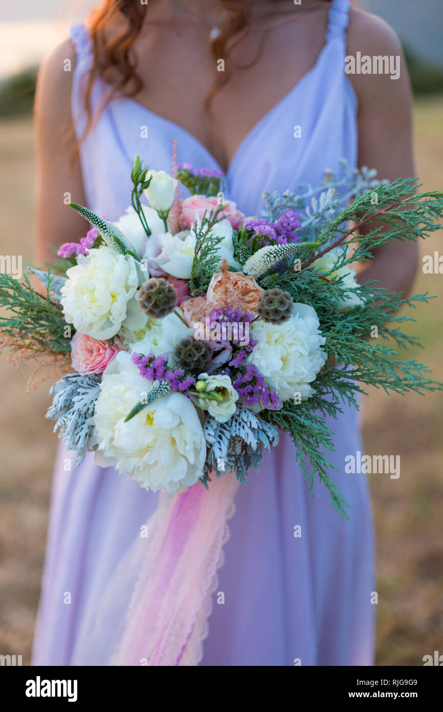 Attractive bride is holding a magnificent wedding bouquet Stock Photo ...