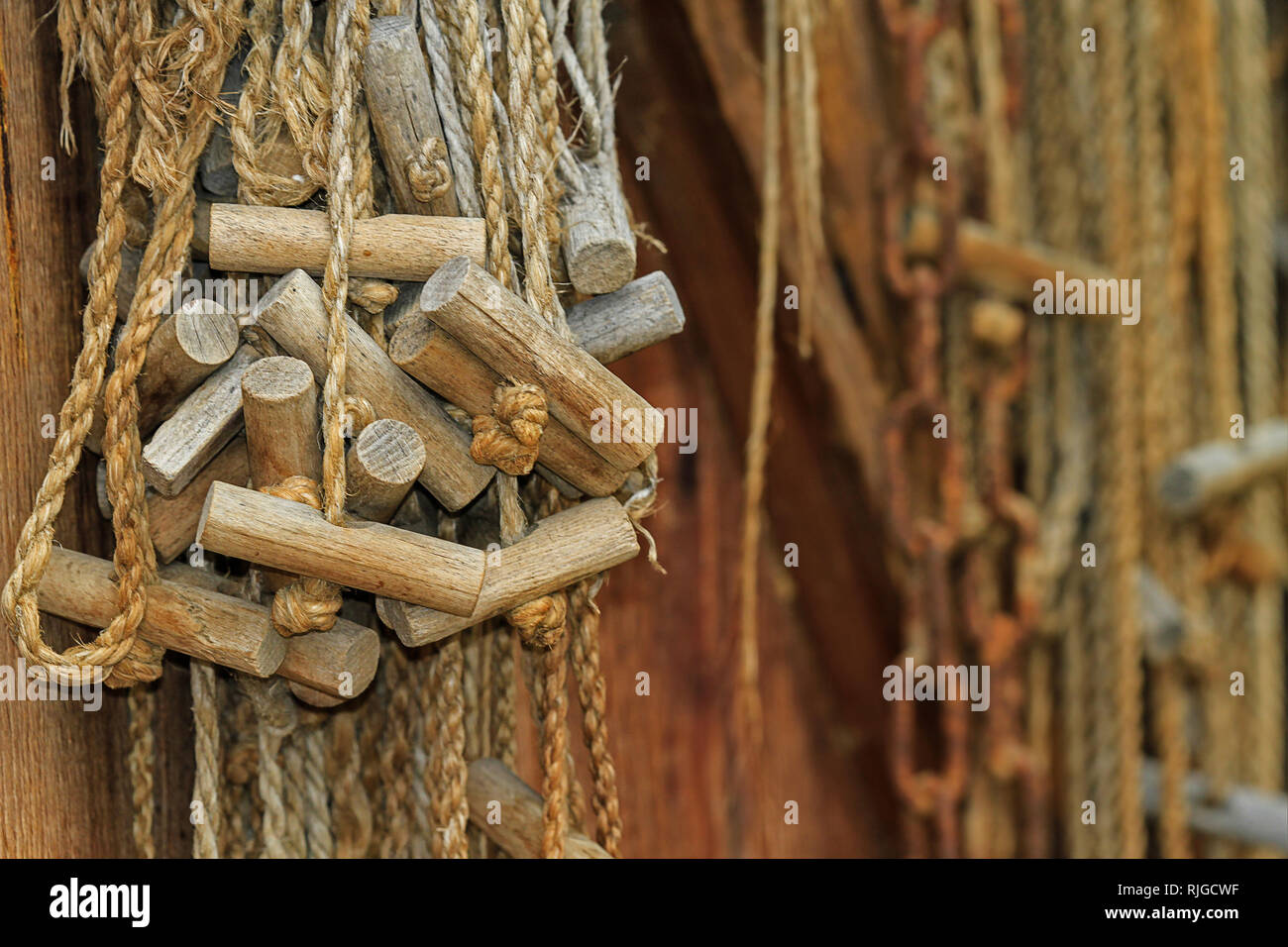 ropes with wooden handles hanging on a wooden wall fishing needs Stock ...