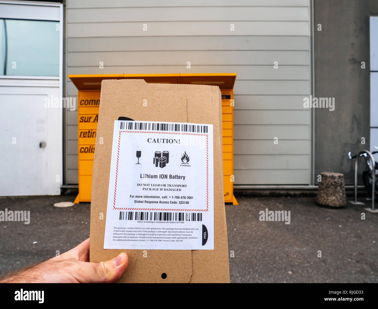 STRASBOURG, FRANCE - MAR 17, 2018: Hand holding parcel package in front ...