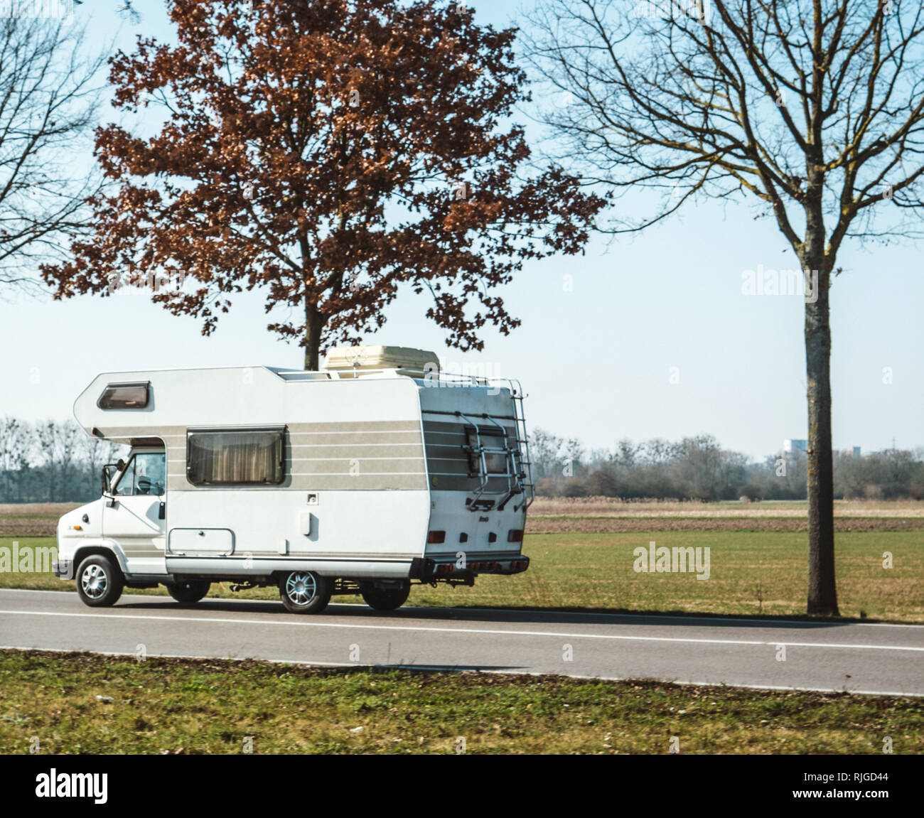 White RV recreational vehicle travel van driving fast on highway to ...