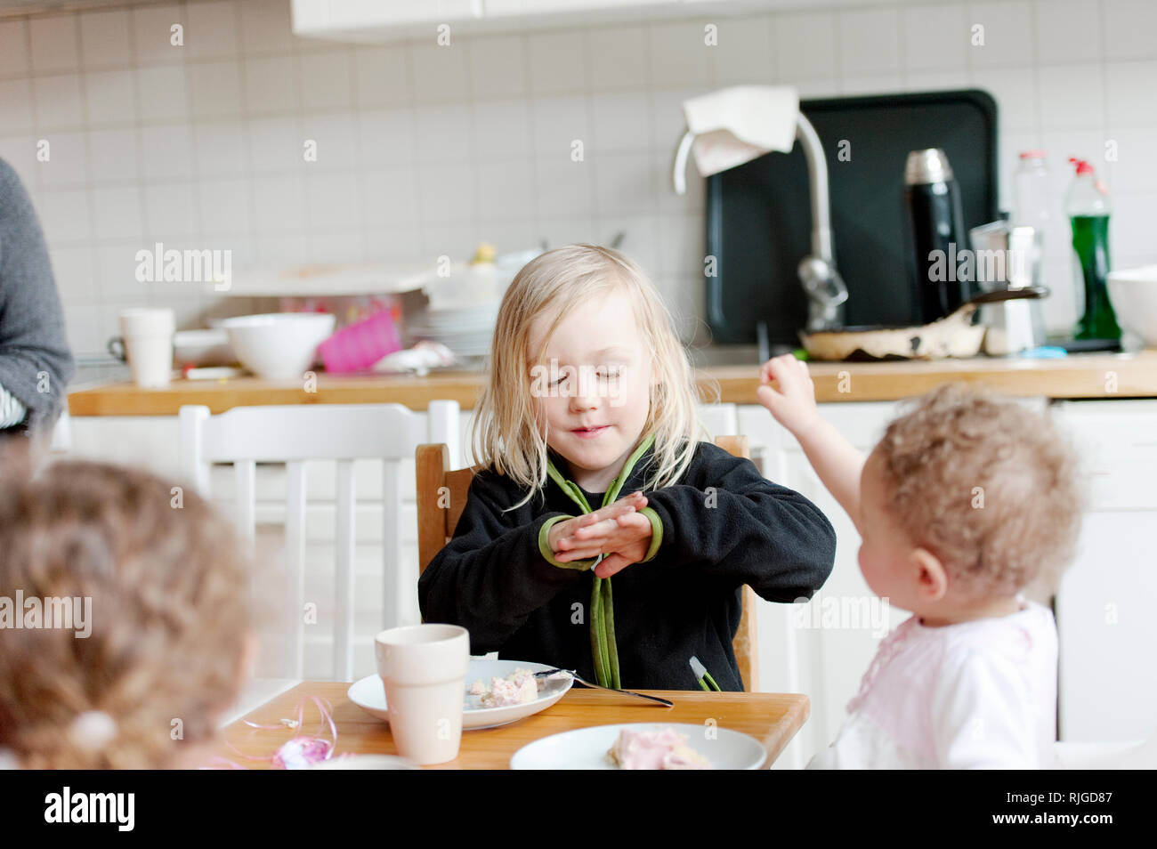Girls eating cake Stock Photo - Alamy