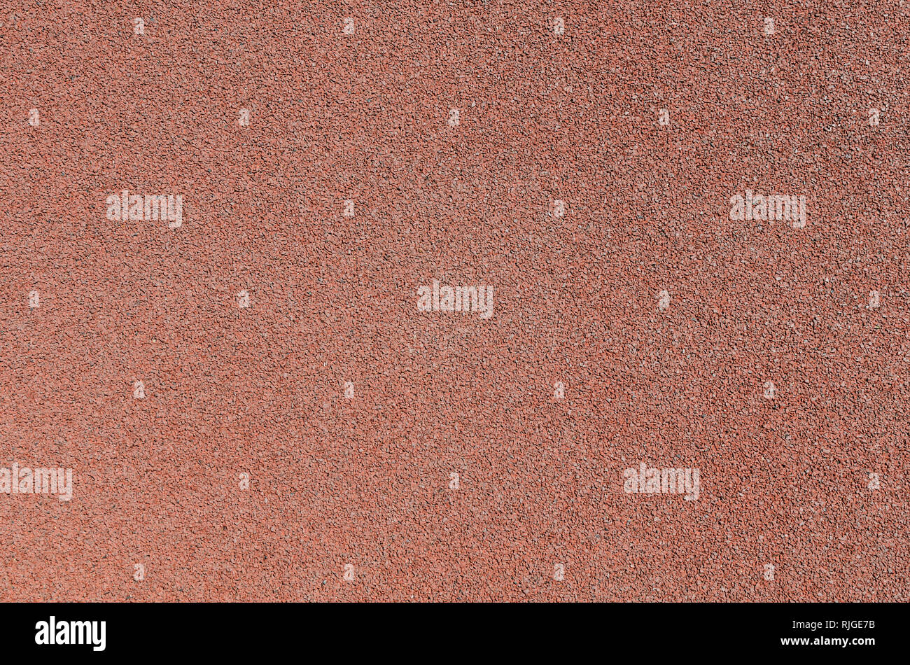 Red rubber covering for sports and playgrounds. Texture Stock Photo - Alamy