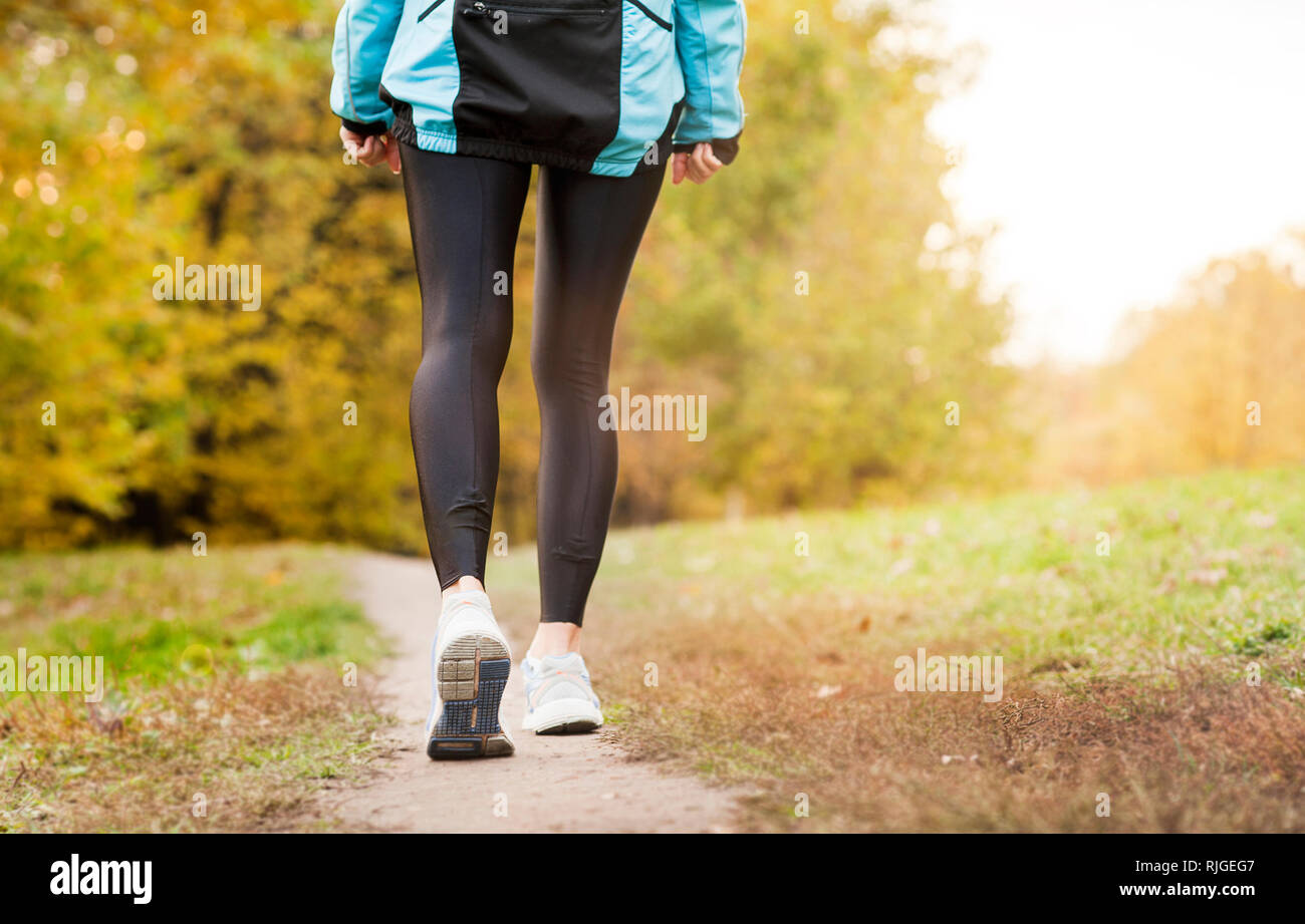 running along a park path, healthcare and problem concept - close-up of ...
