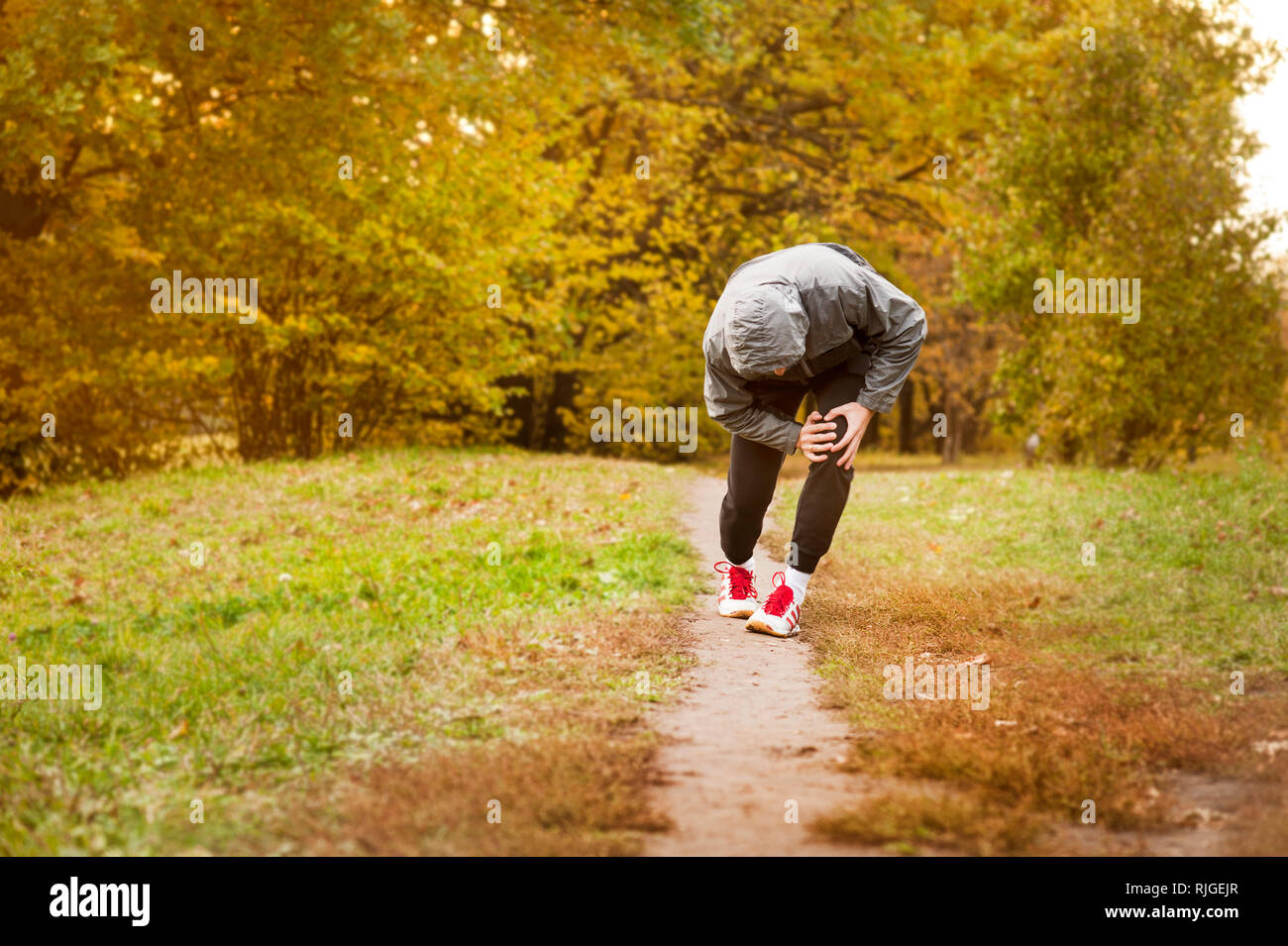 running along a park path, healthcare and problem concept - close-up of ...
