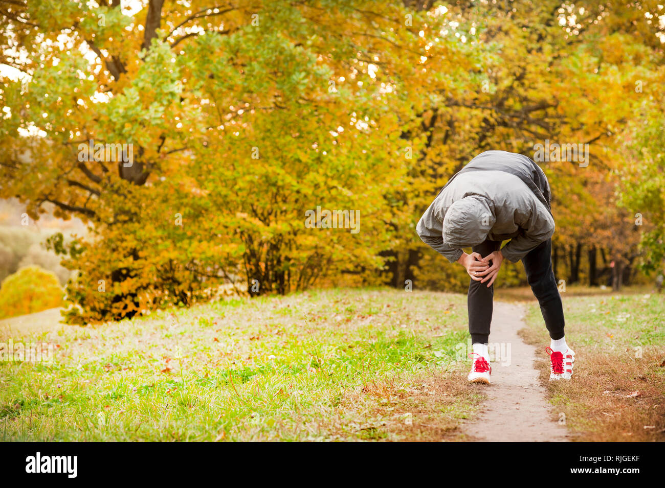 running along a park path, healthcare and problem concept - close-up of ...