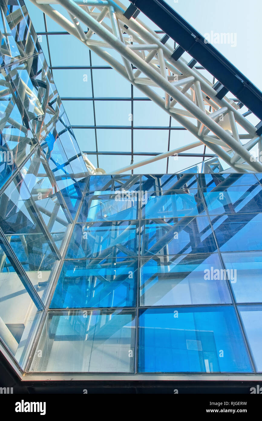 Trendy architecture with blue glass panels in a metal construction ...