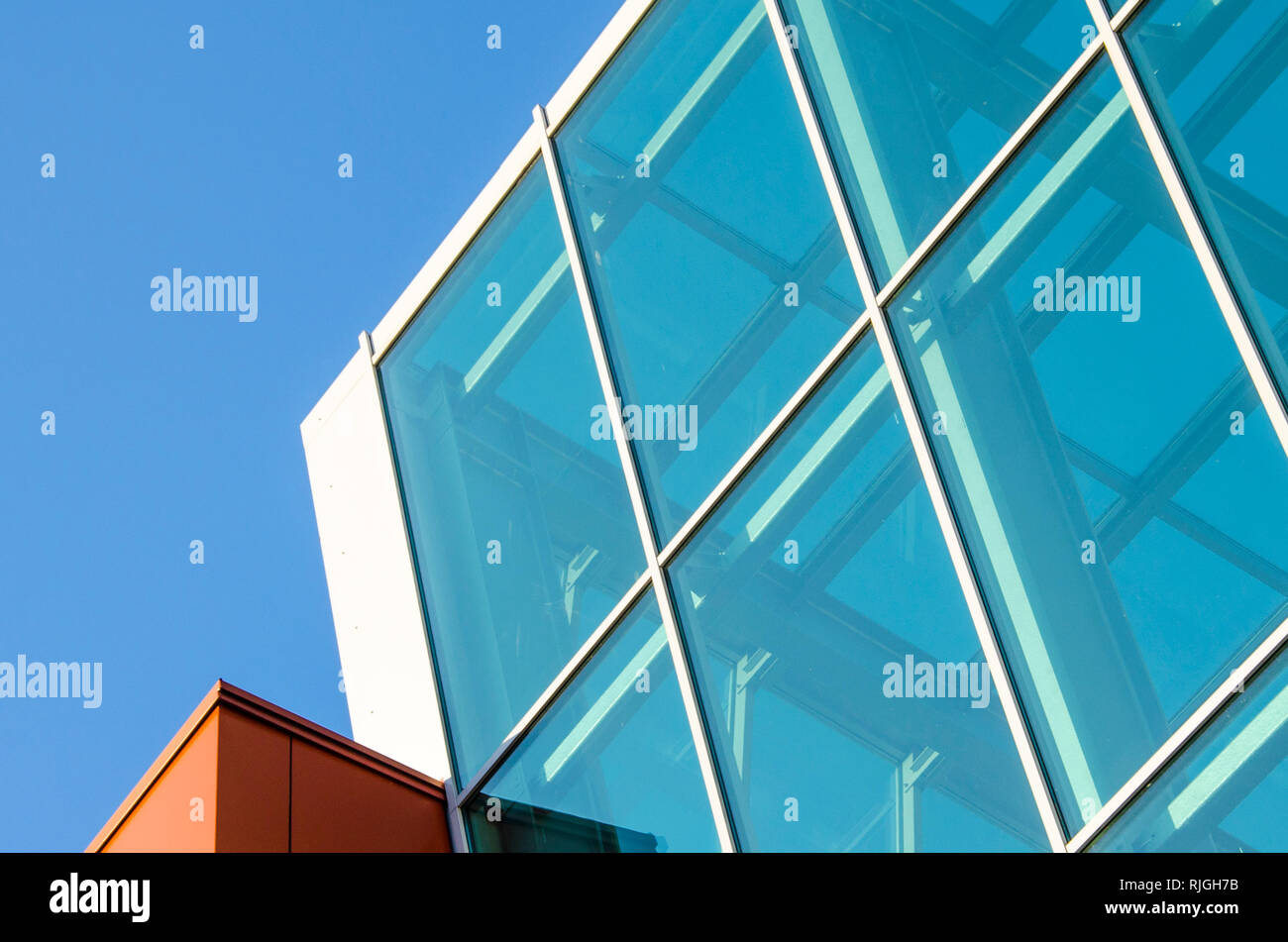 Geometrical shapes of a modern building of glass and stone against ...
