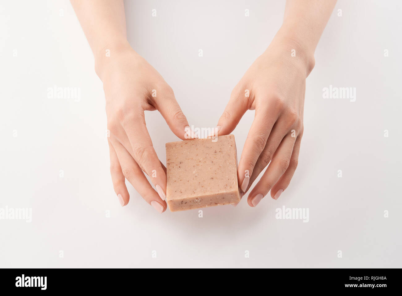Partial view of woman holding soap on white background Stock Photo - Alamy