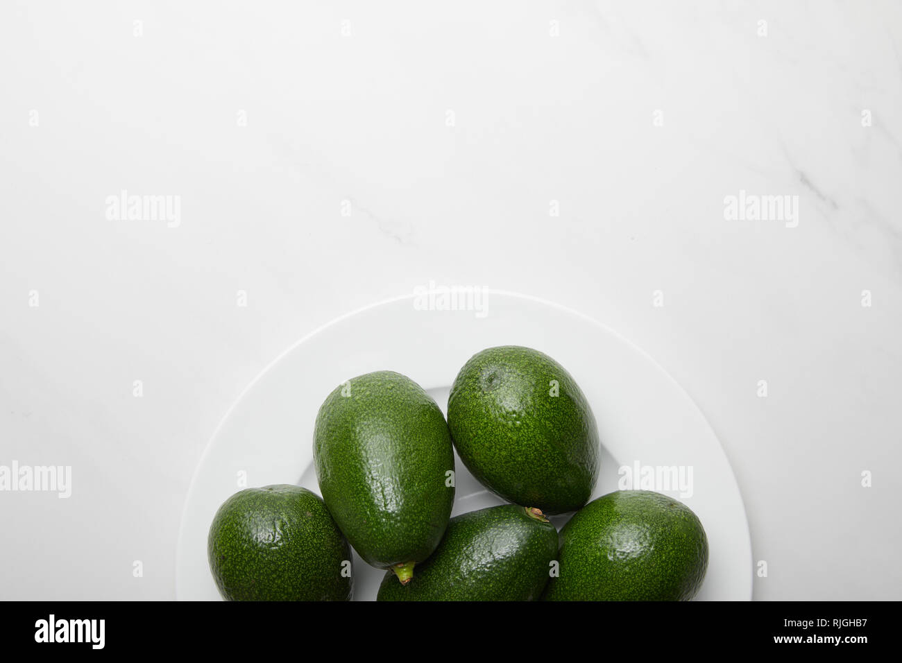 Avocados white plate hi-res stock photography and images - Alamy