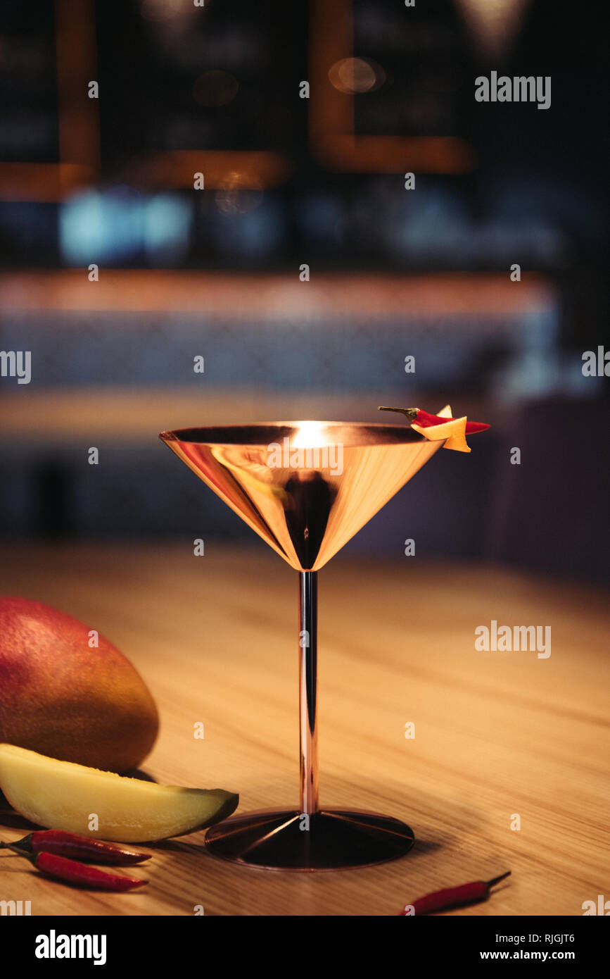 alcoholic cocktail in metal glass decorated with chili pepper, nacho ...