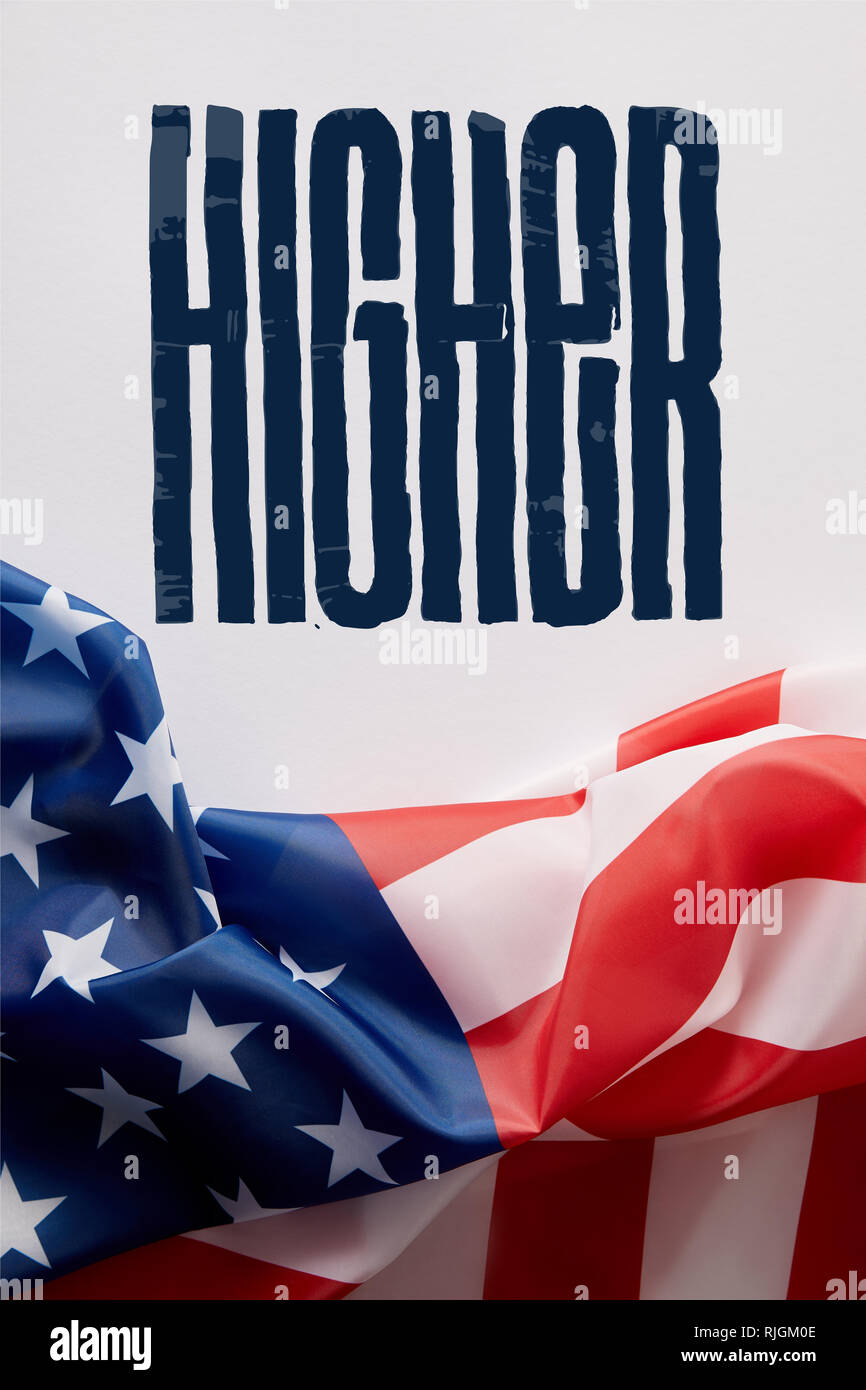 top view of united states of america flag and higher lettering on white ...