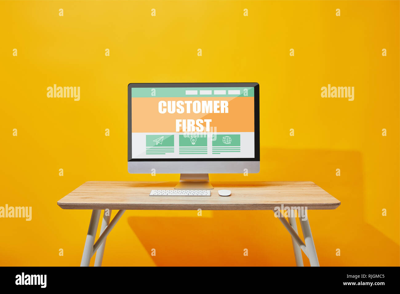 Computer with keyboard and mouse at wooden table with customer first ...