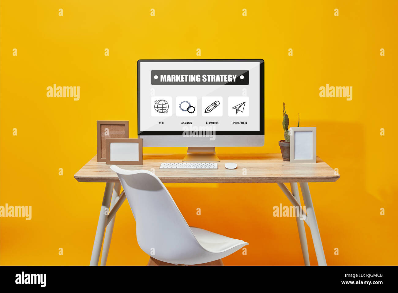 Computer with marketing strategy website on screen at wooden table on ...