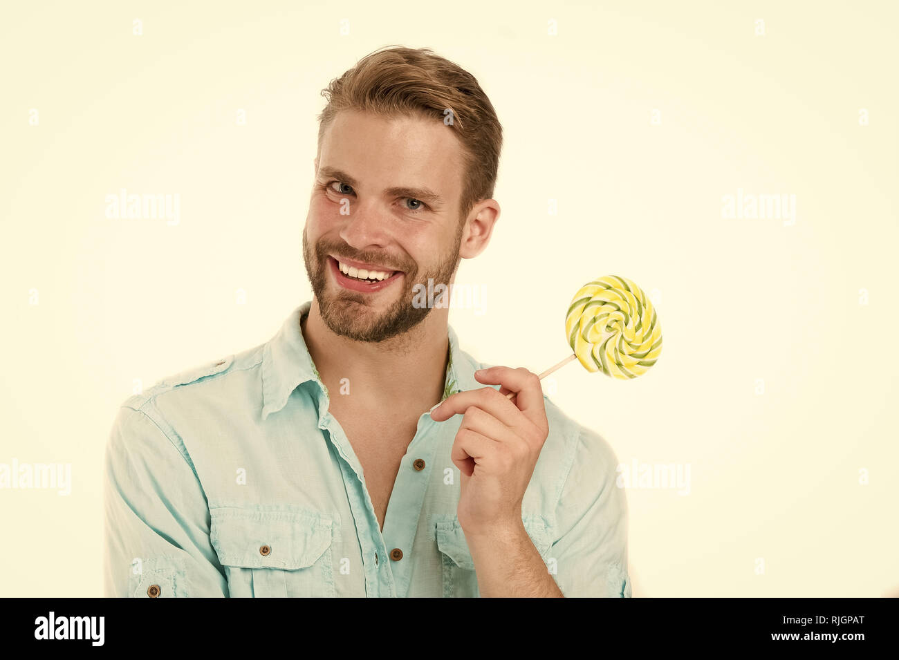 Happy macho with lollipop. Man smile with candy on stick isolated on ...