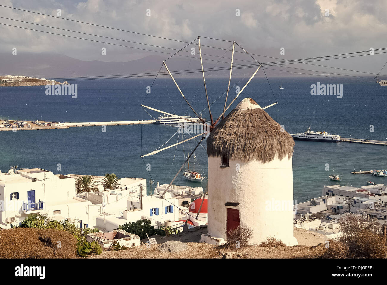 Windmill on seascape in Mykonos, Greece. Windmill on mountain by sea on ...