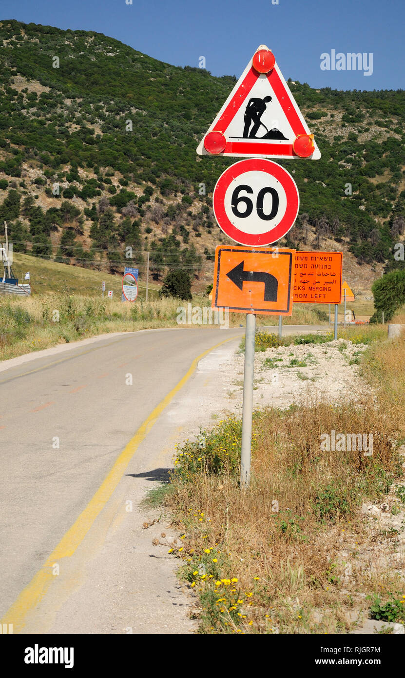 Three traffic signs with green hill at the background. Northern Israel ...