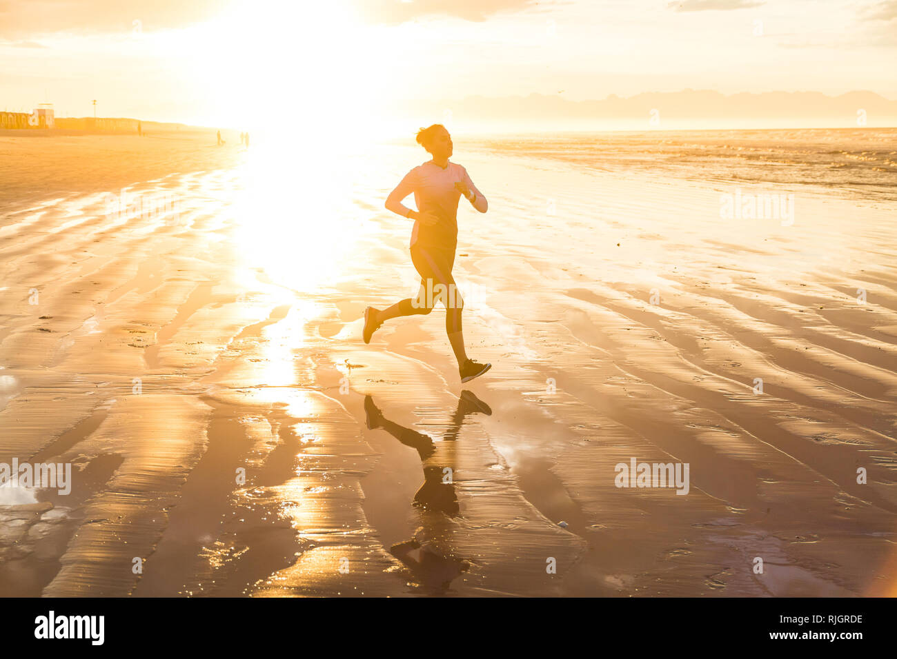 Female runner jogging on sea hi-res stock photography and images - Alamy