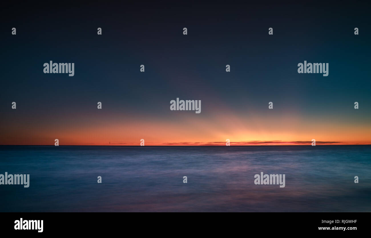 Sunset on the ocean Stock Photo - Alamy