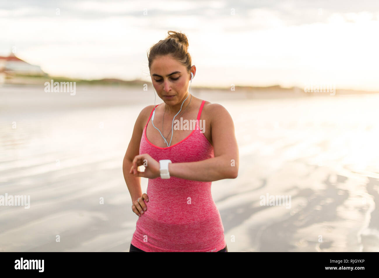 Young female runner checking her time on a smartwatch Stock Photo - Alamy