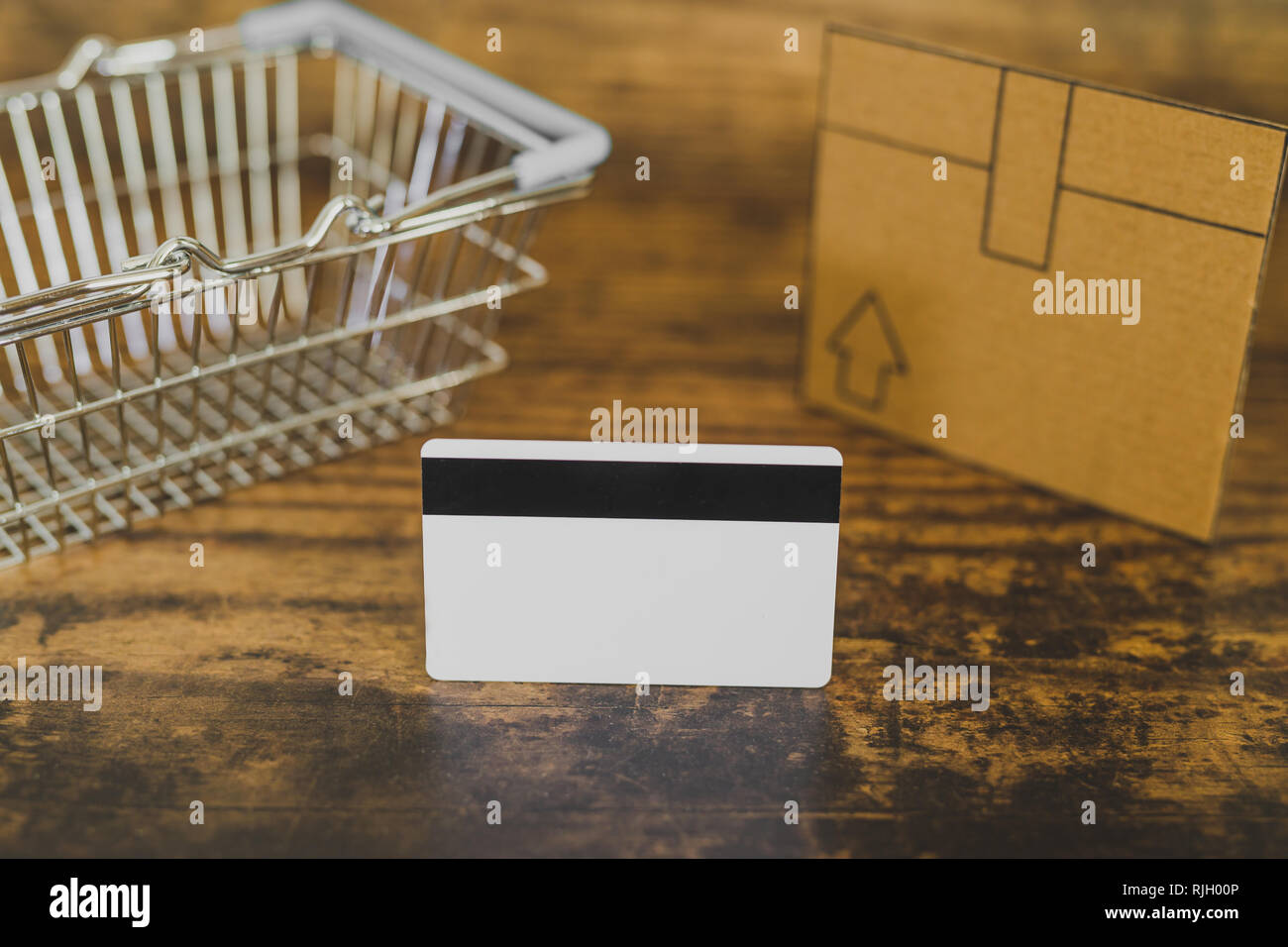 empty shopping basket with payment card and delivery box, concept of ...