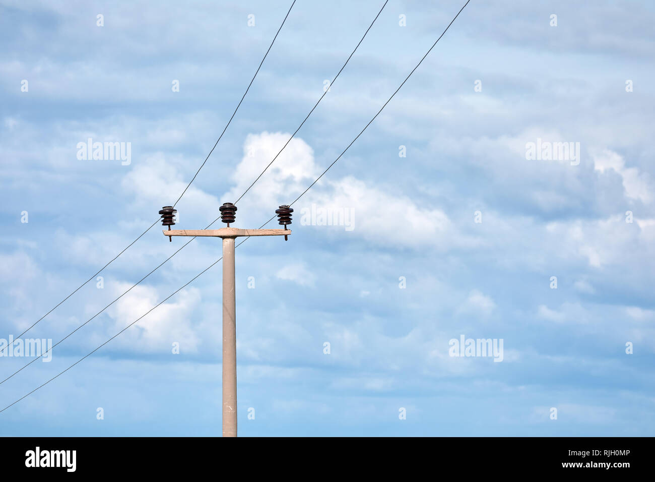 Minimalist view of a concrete high voltage power electric pole, power ...