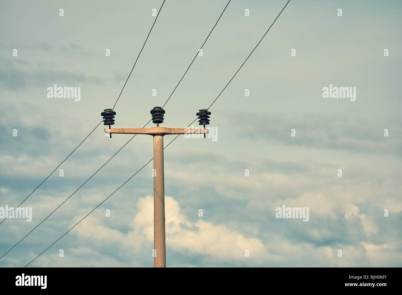 Minimalist view of a concrete high voltage power electric pole, power ...