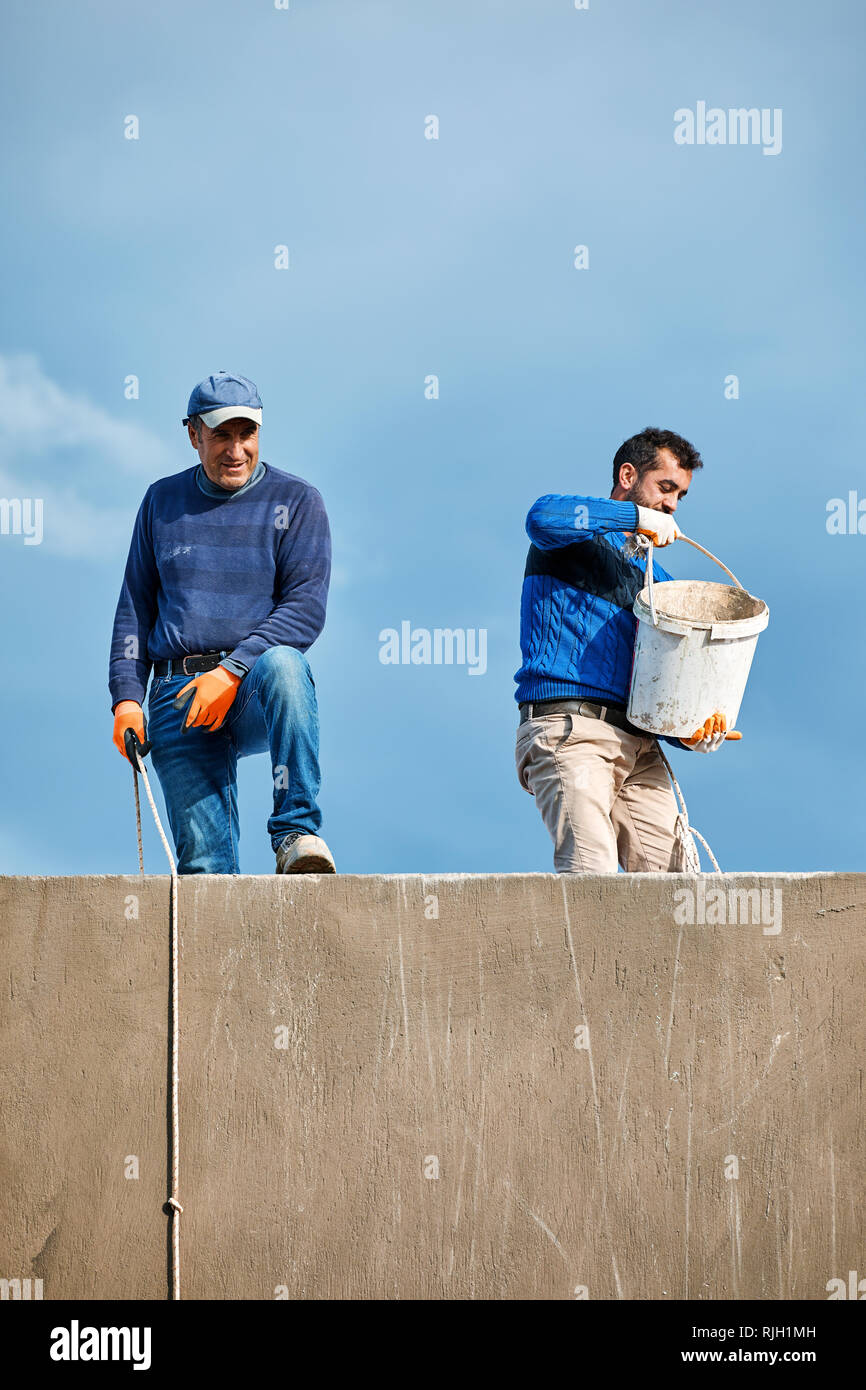 Bodrum, Turkey - January 2019: Two Turkish construction workers working ...