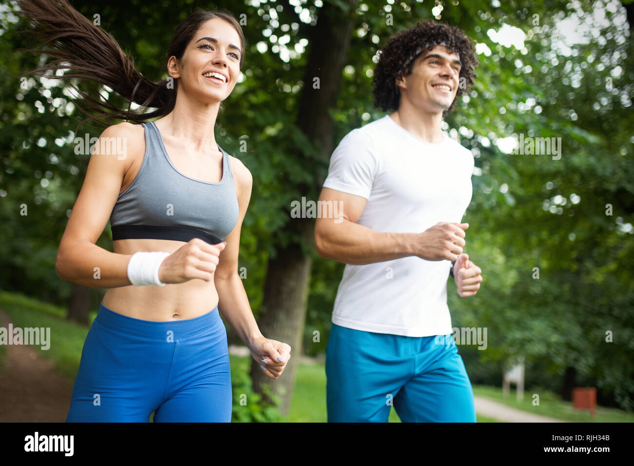 Happy couple running and jogging together outdoor Stock Photo - Alamy