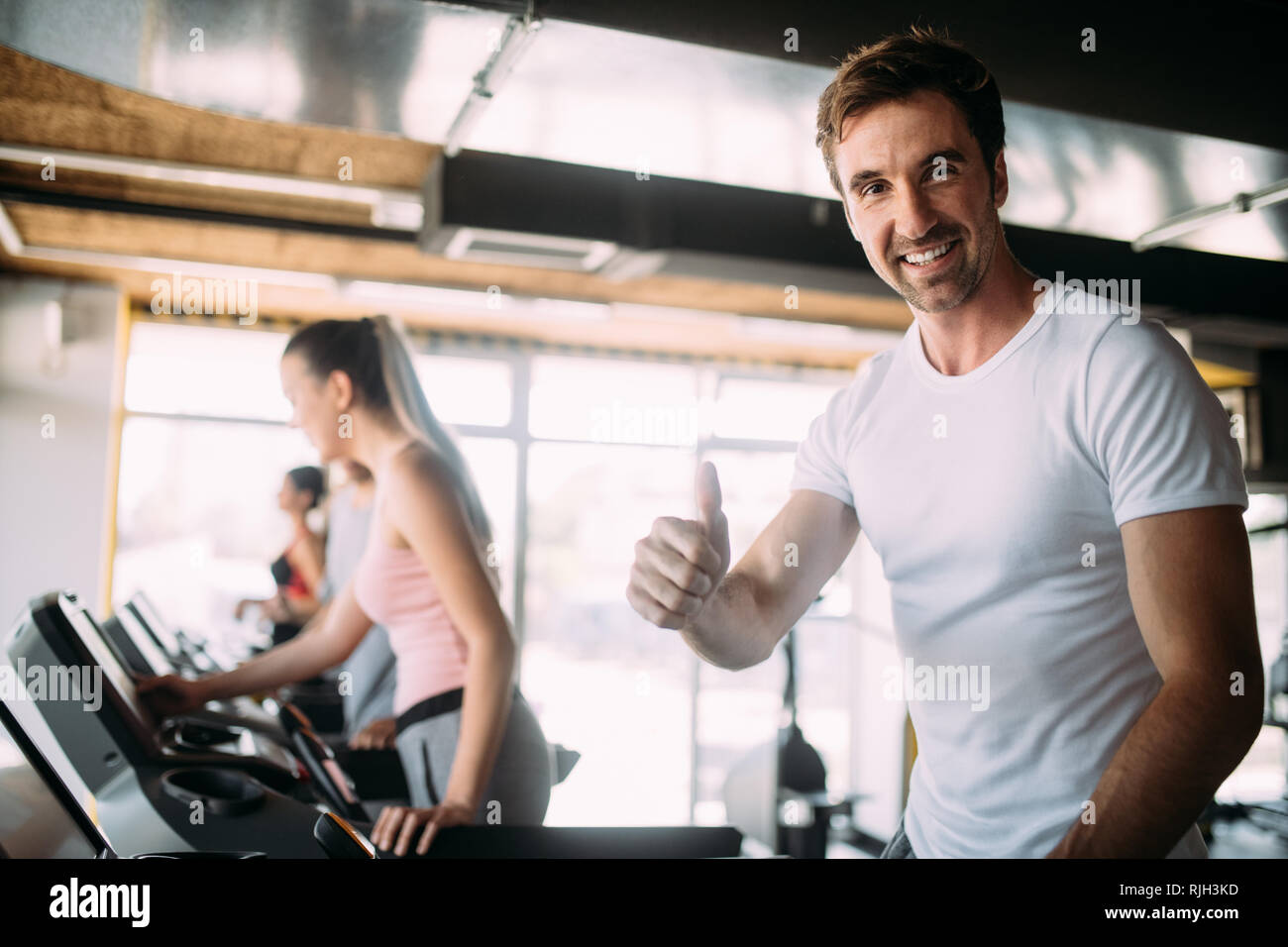 Fit people running in machine treadmill at fitness gym Stock Photo - Alamy