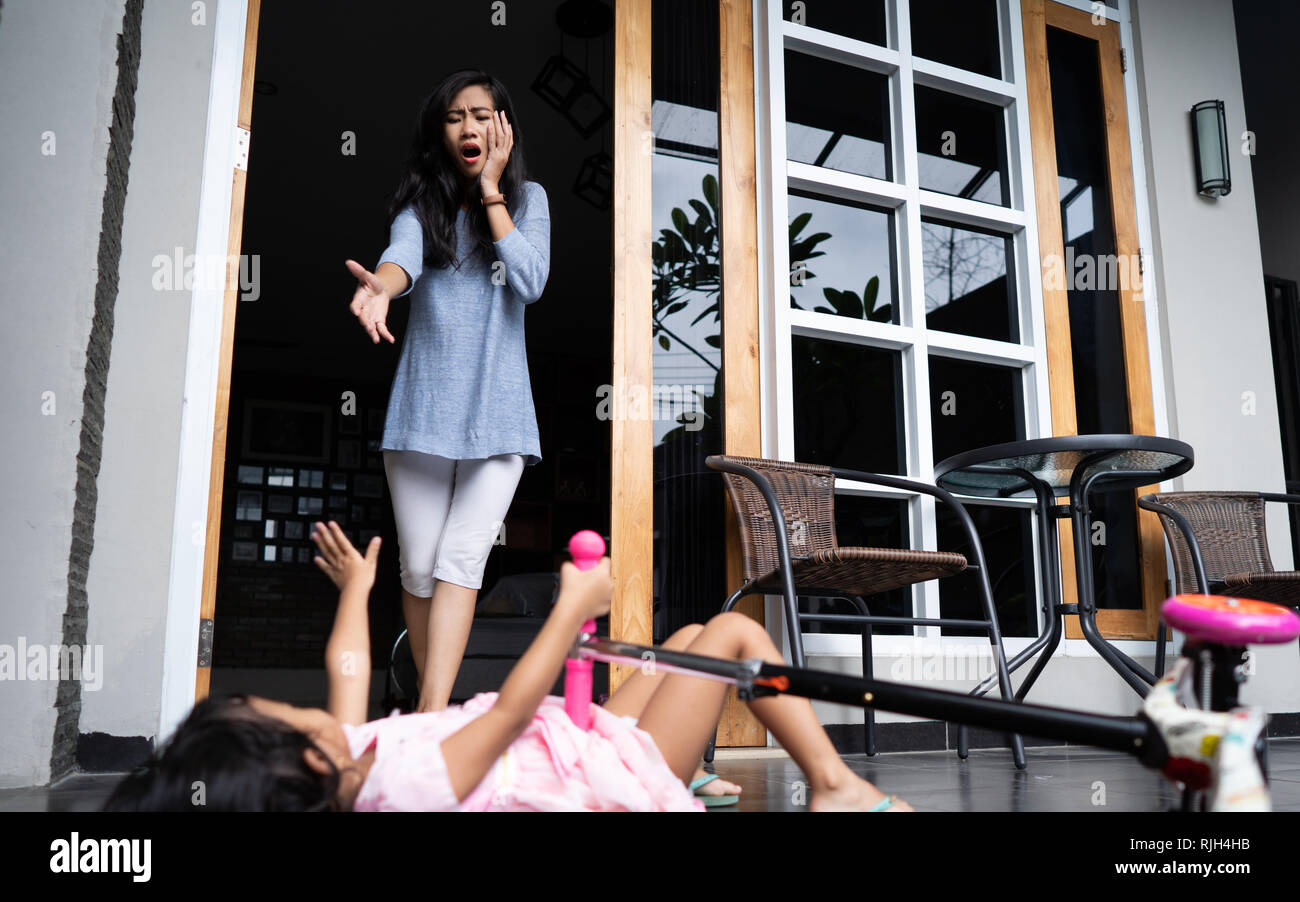 shocked mom looking at her daughter fell from scooter Stock Photo - Alamy