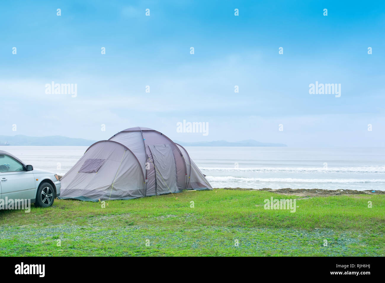 Seascape summer travel machine tent rubber boat. Coastline horizon sky ...