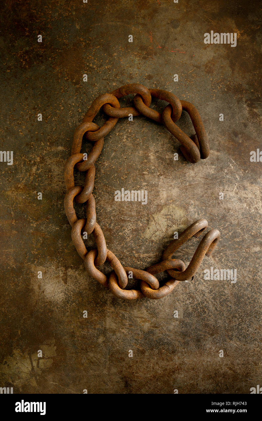 Rusty chain in shape of letter C Stock Photo - Alamy
