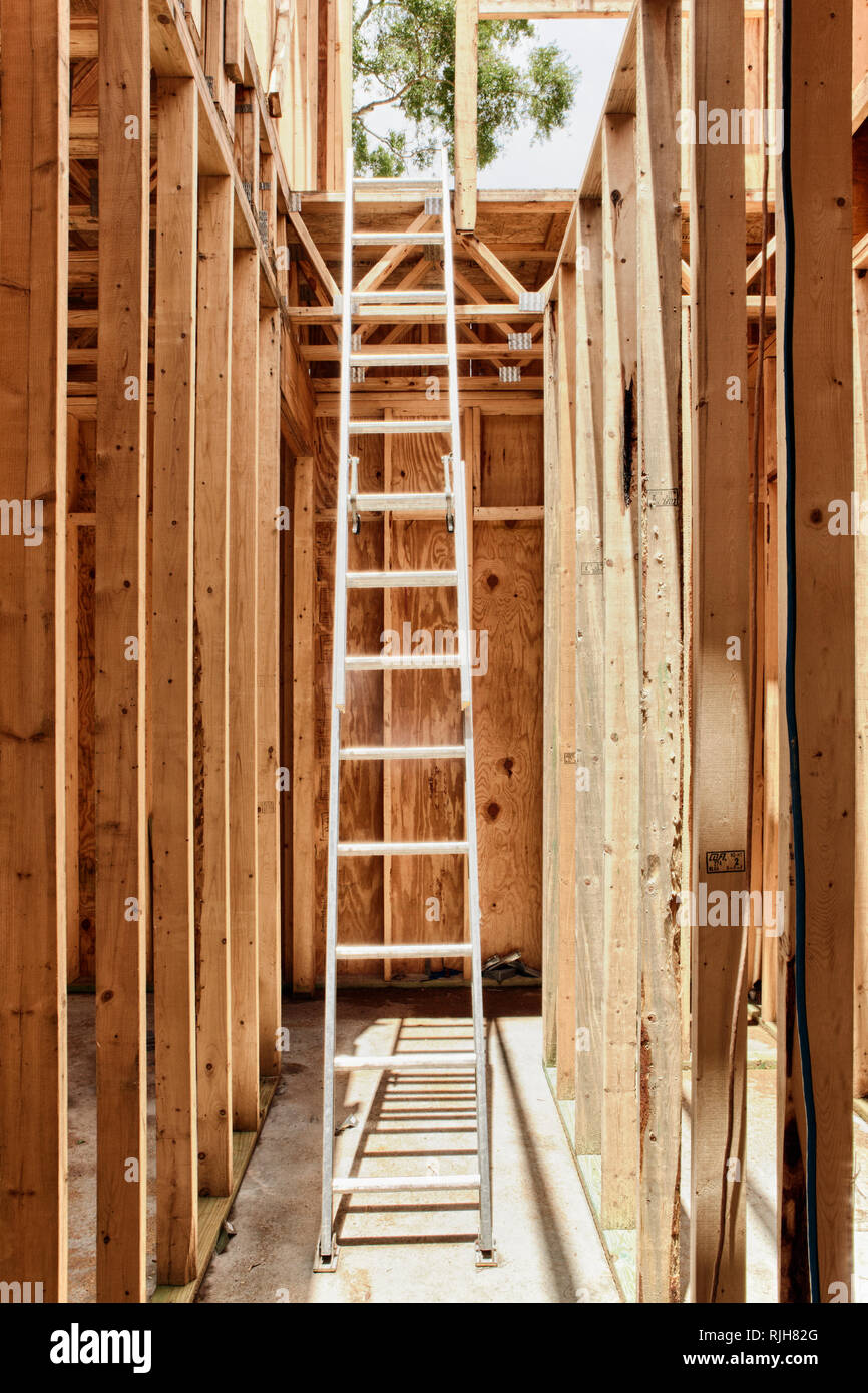 Tall Extension Ladder in an Unfinished Building Stock Photo - Alamy