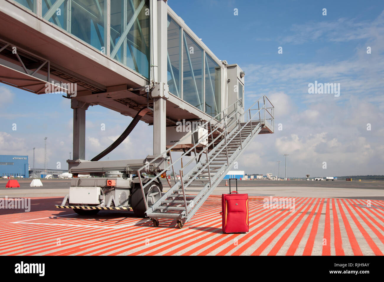 Suitcase outside airport passenger boarding bridge Stock Photo - Alamy