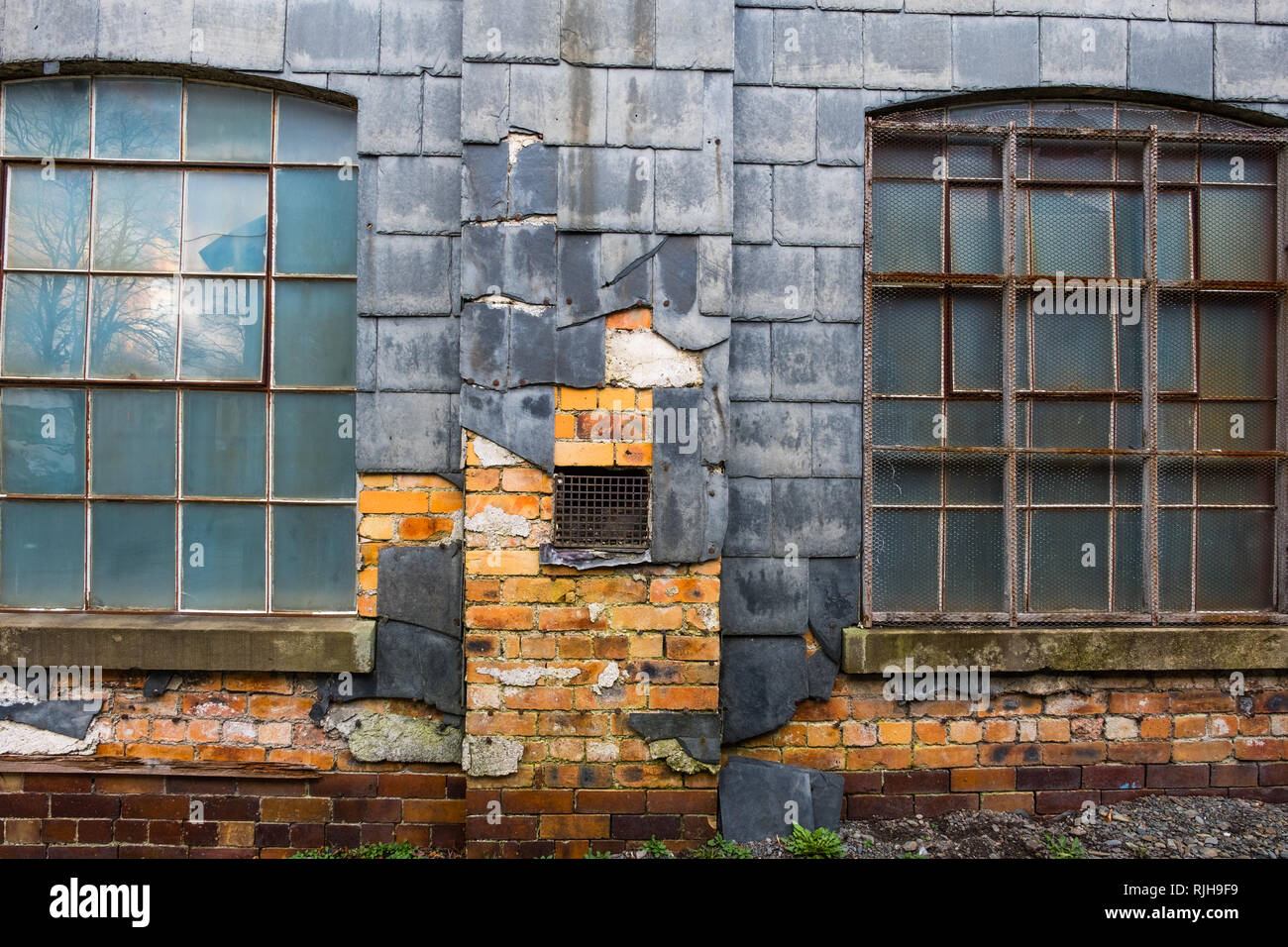 Old and damaged Slate cladding on the exterior of brick built houses ...
