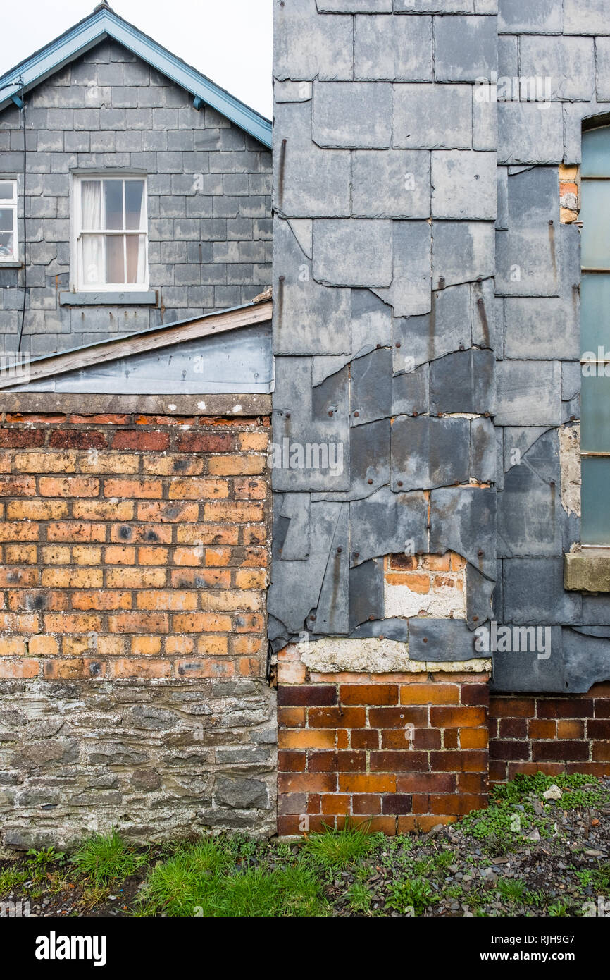 Old and damaged Slate cladding on the exterior of brick built houses ...